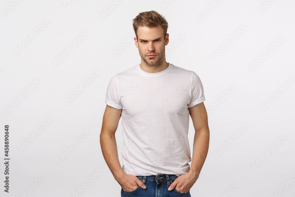 Angry, judgemental handsome macho blond male model in white t-shirt ...
