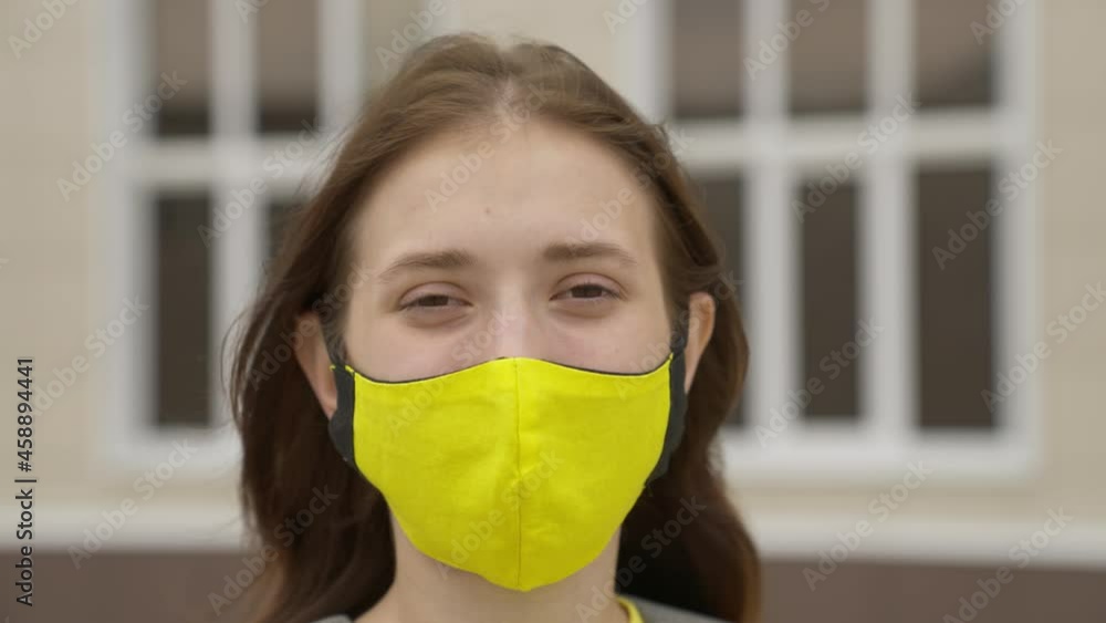 Vidéo Stock An adult schoolgirl puts on a face mask and smiles ...