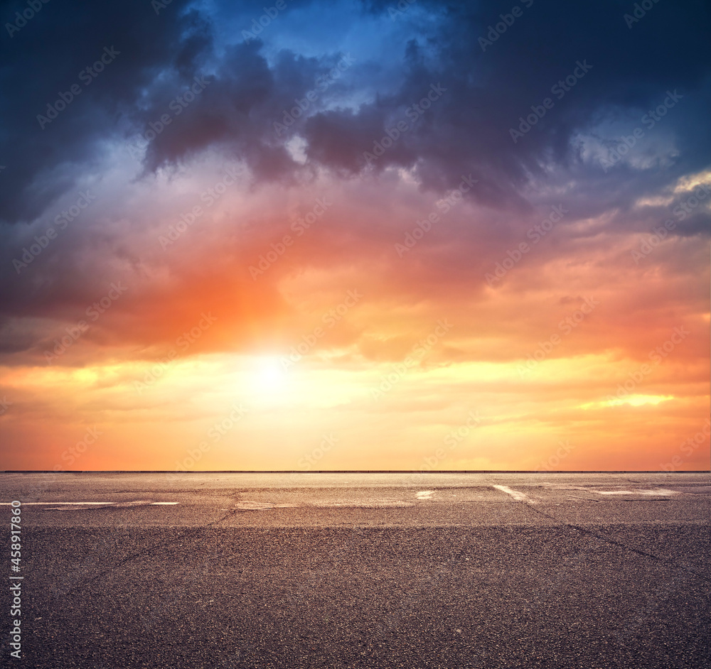 Asphalt road with dramatic sunset sky, side view Stock Photo | Adobe Stock