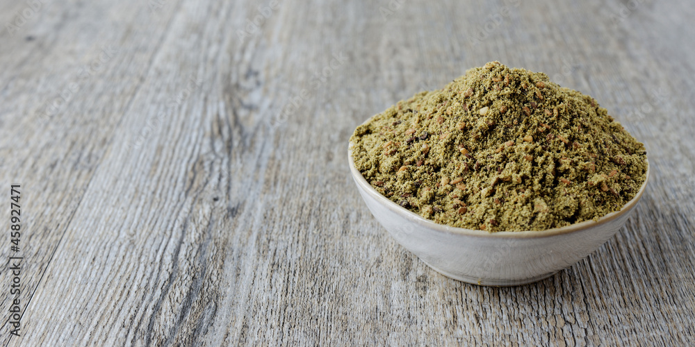 Green Za'atar spice blend heap in a bowl. Traditional Middle East ...