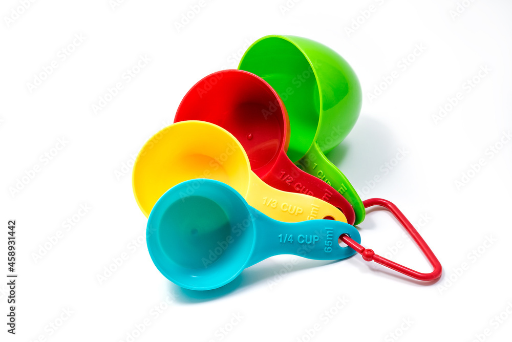 Four pieces of colorful ingredient measuring scoops or spoons of ...