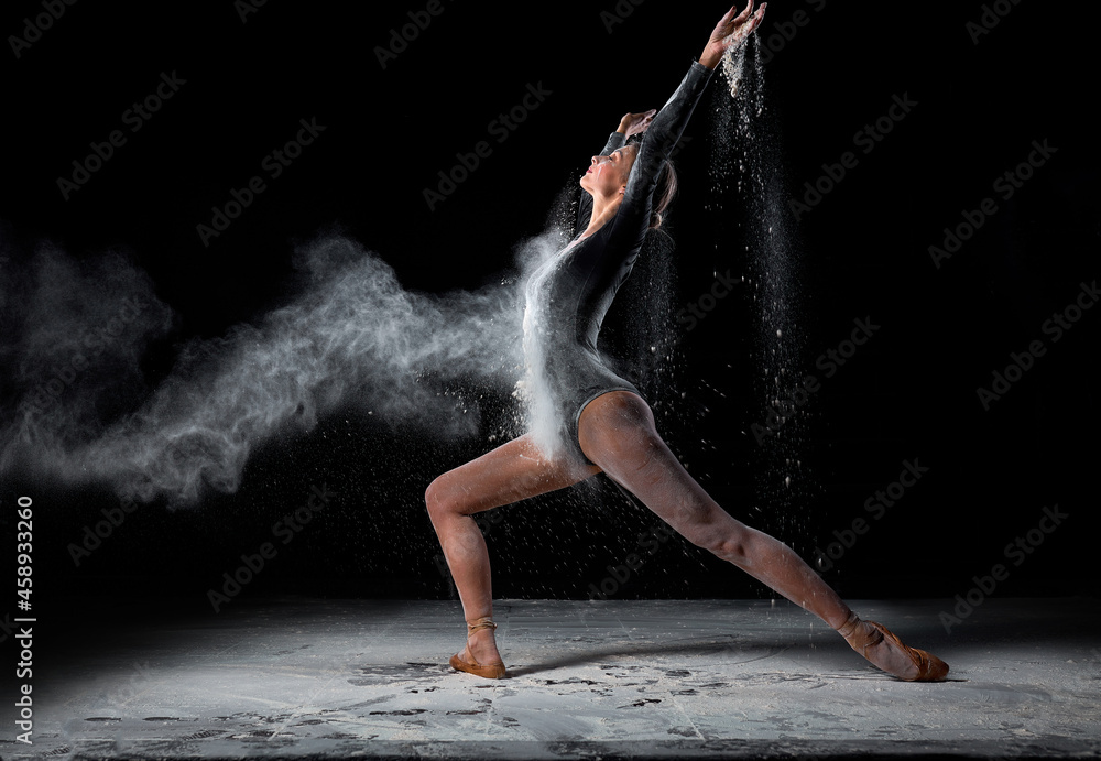 Dancing in flour concept. Caucasian Ballerina woman dancer in dust fog ...