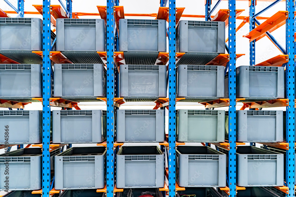 plastic boxes in the cells of the automated warehouse. Metal ...