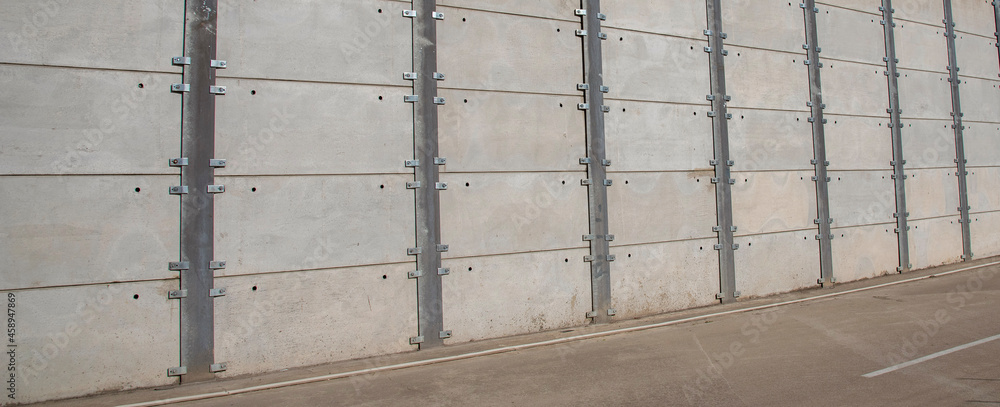 Southampton, England, UK, 2021. A long high security wall of conrete ...