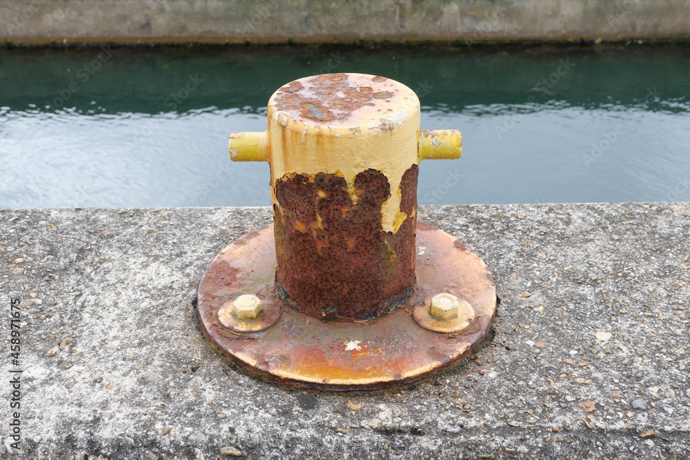 Mooring bollard on paving on harbourside with water in background Stock ...