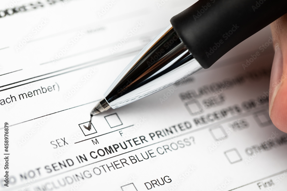 Person marking gender checkbox in a form Stock Photo | Adobe Stock