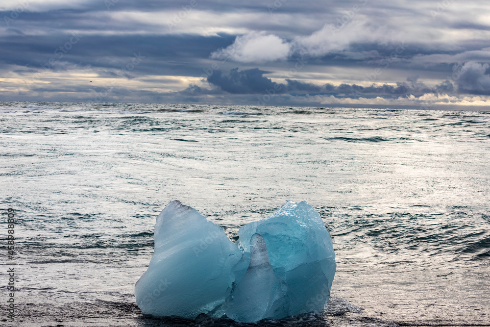 amazing blue colored icebergs washed ashore the black sand beach ...