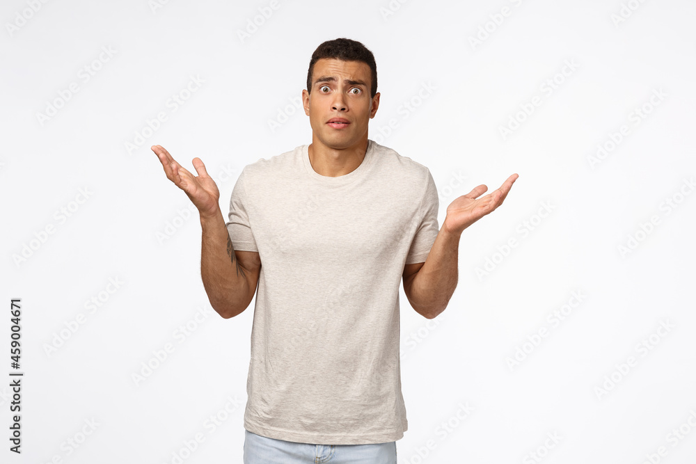 Concerned and alarmed tanned muscline young man standing shocked and ...