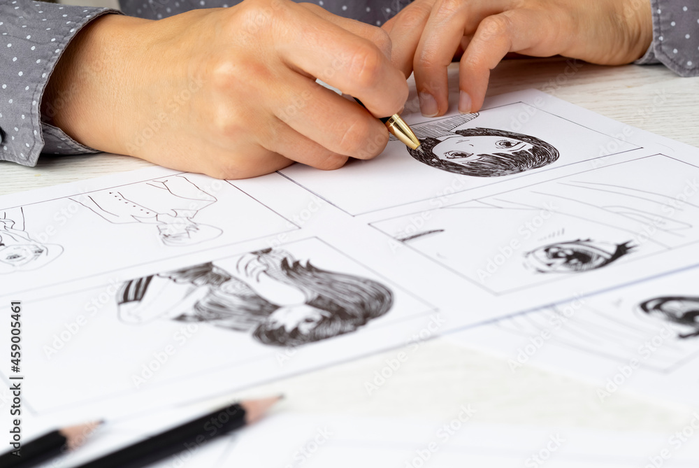 The artist draws anime comics on paper. Storyboard for the cartoon. The ...