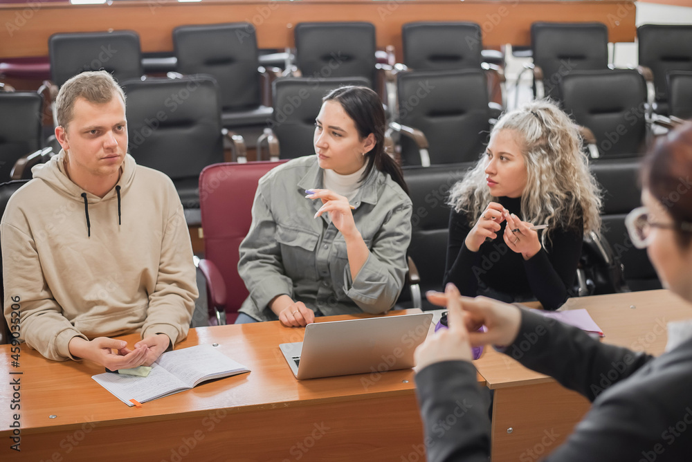 The teacher and students communicate in sign language in the classroom ...