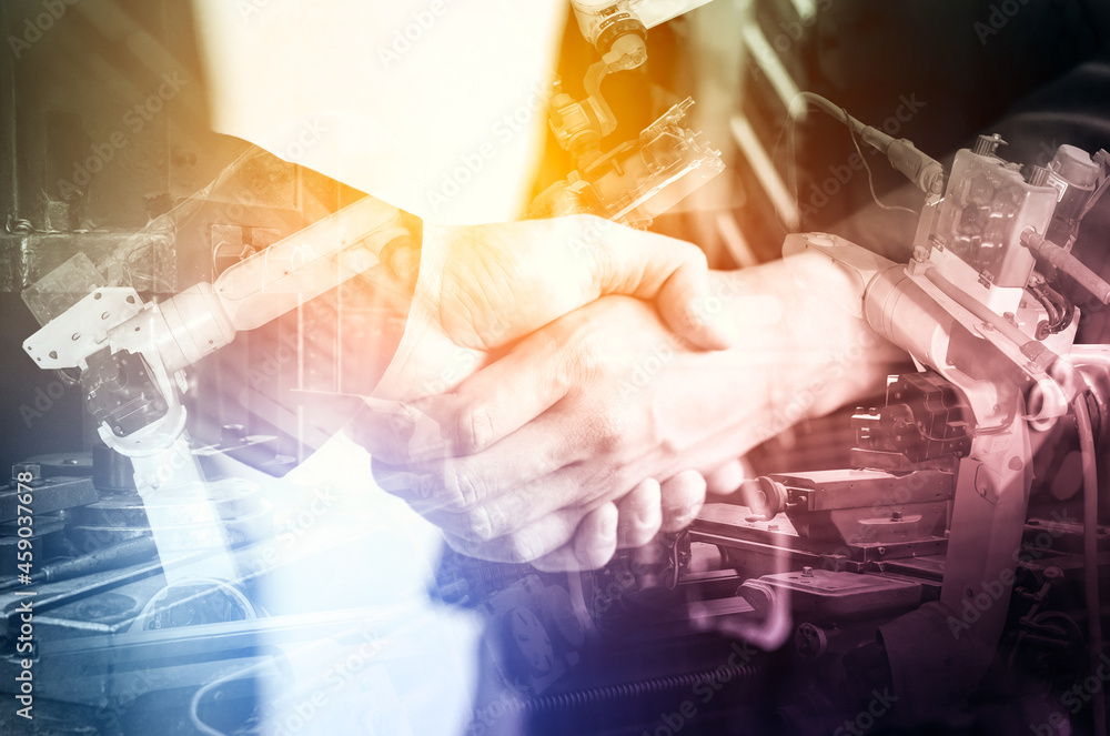 Foto de Mechanized industry robot arm and business handshake double ...