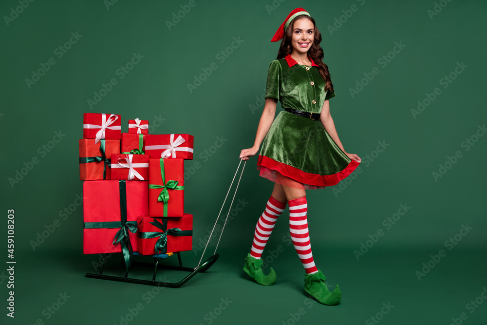 Full length body size view of pretty cheerful girl elf Santa helper ...