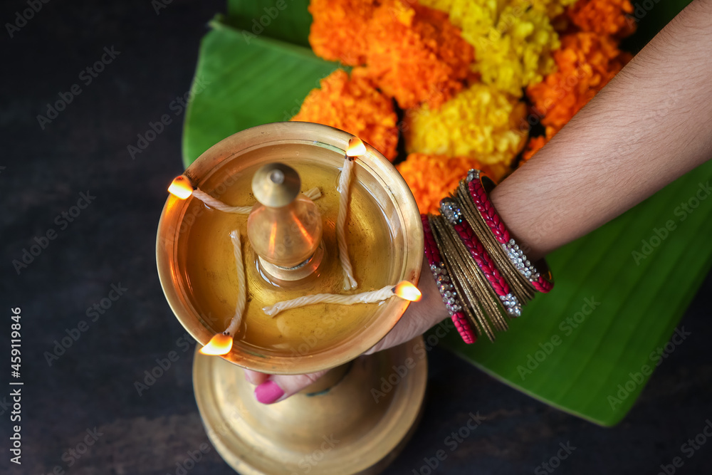 Indian woman holding ighted oil lamp Onam Diwali vishu celebration ...