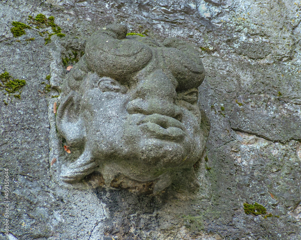 The head of a mythical character, carved out of stone, is located on ...