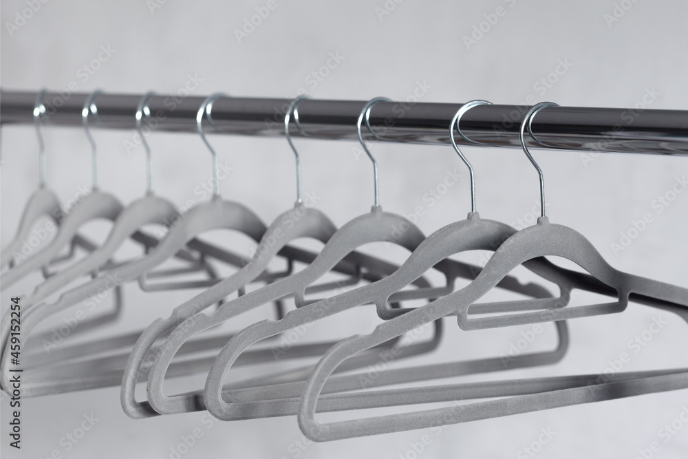 Modern grey empty hangers on neutral wall background Stock Photo ...