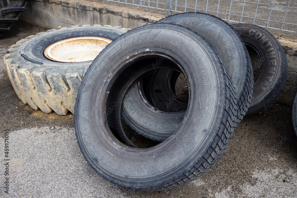 Stack of old used tires of different sizes and types in abandoned scrap ...
