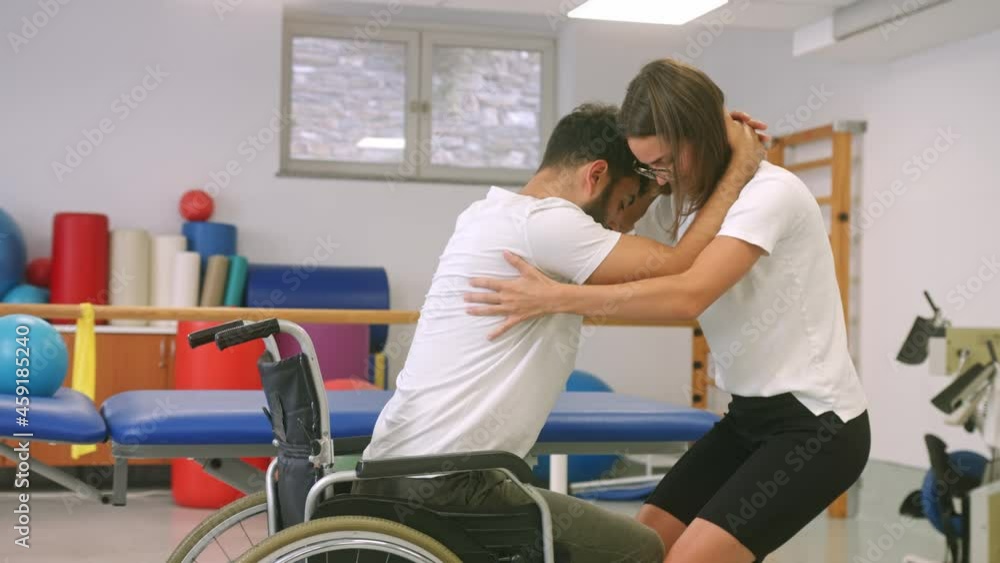 Handheld shot of a Caucasian male disabled patient, and female ...