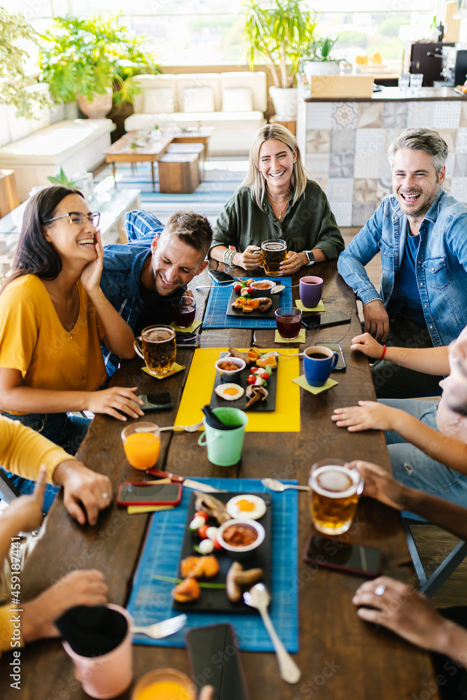 Group of young people having fun drinking on a rooftop terrace of a ...