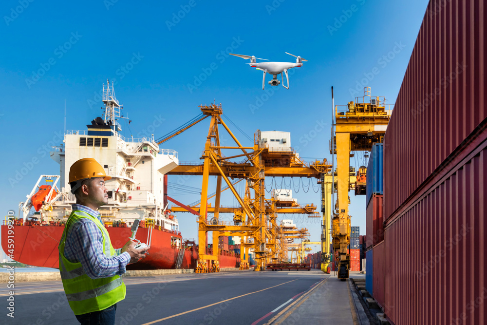 Drone operator for survey container with crane bridge in shipyard with ...