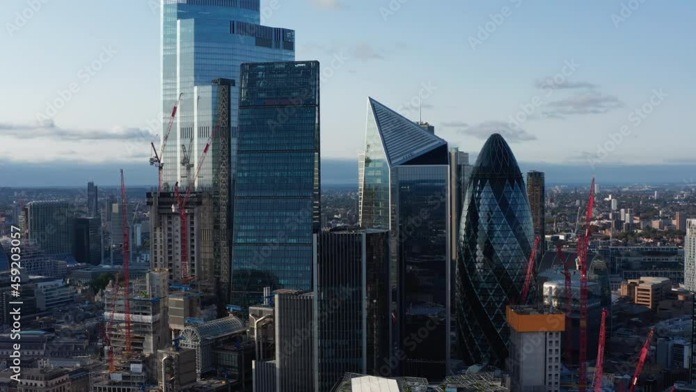 Slide and pan footage of futuristic office buildings in City. Gherkin ...