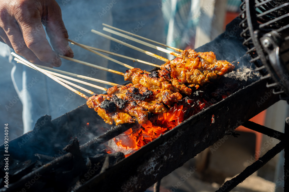 Chicken satay on traditional charcoal fire. satay on fire with smoke ...