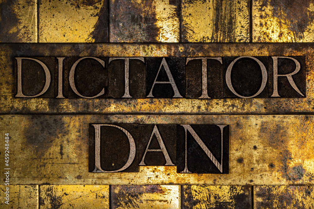 Dictator Dan text on textured grunge copper and vintage gold background ...