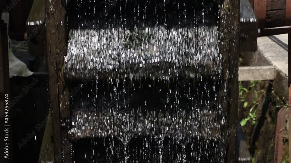 The mill wheel rotates under a stream of water, close up. Stock ビデオ ...