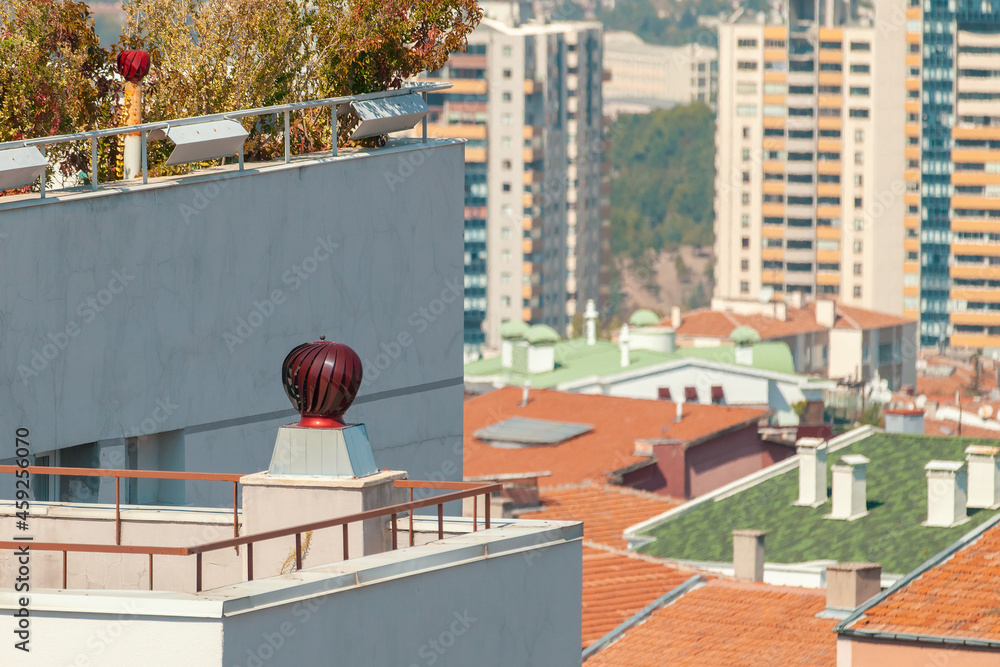 Big and small air ventilation on the chimneys of a building. Rotating ...