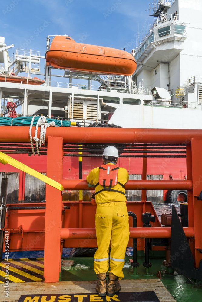 Foto de An offshore construction supervisor leaning on the railing ...