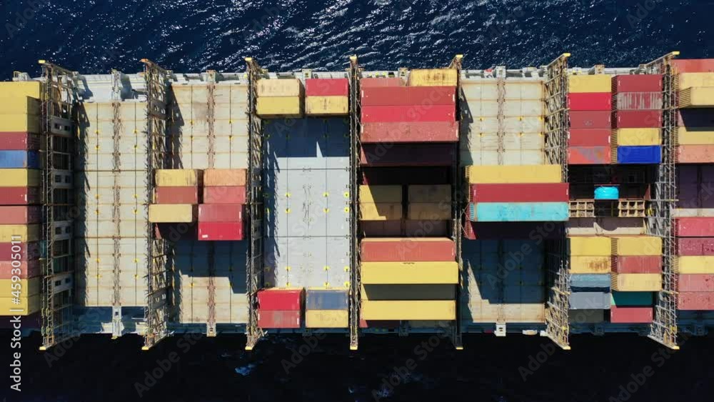 Aerial top down tracking video of Container cargo Ship carrying load in ...