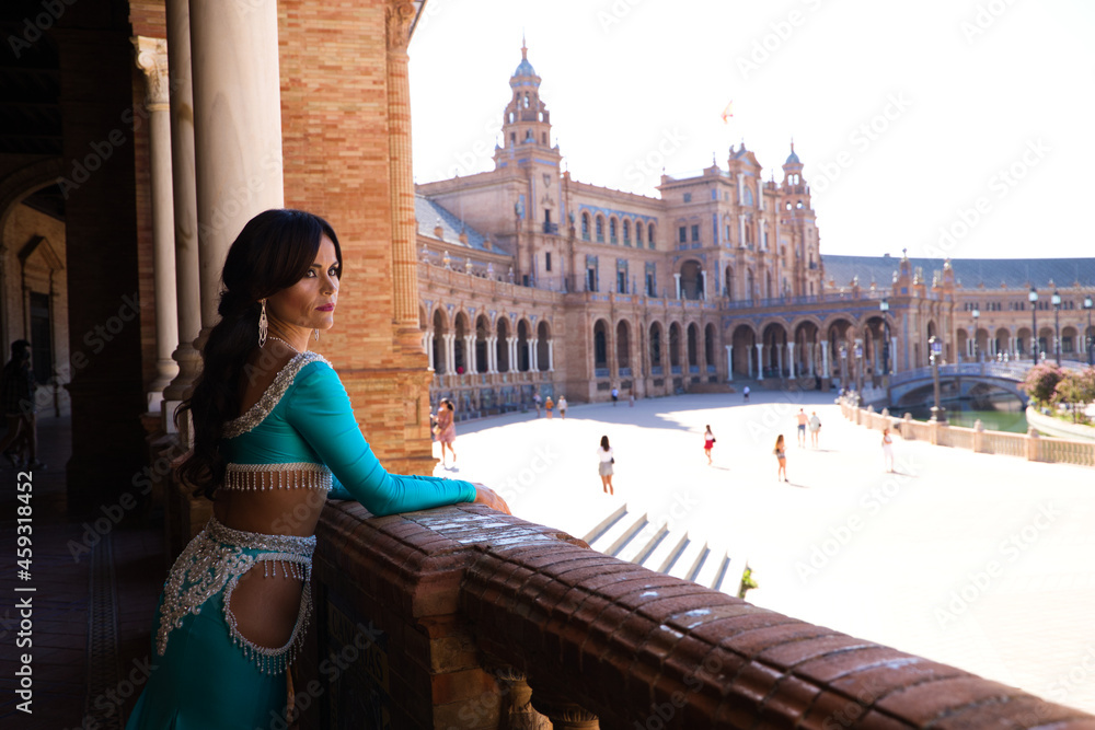 beautiful young belly dancer is posing for the camera in a photo shoot ...