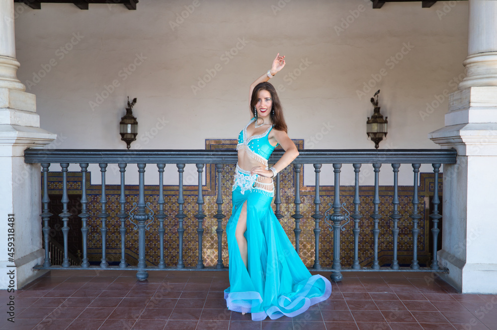 beautiful young belly dancer is posing for the camera in a photo shoot ...