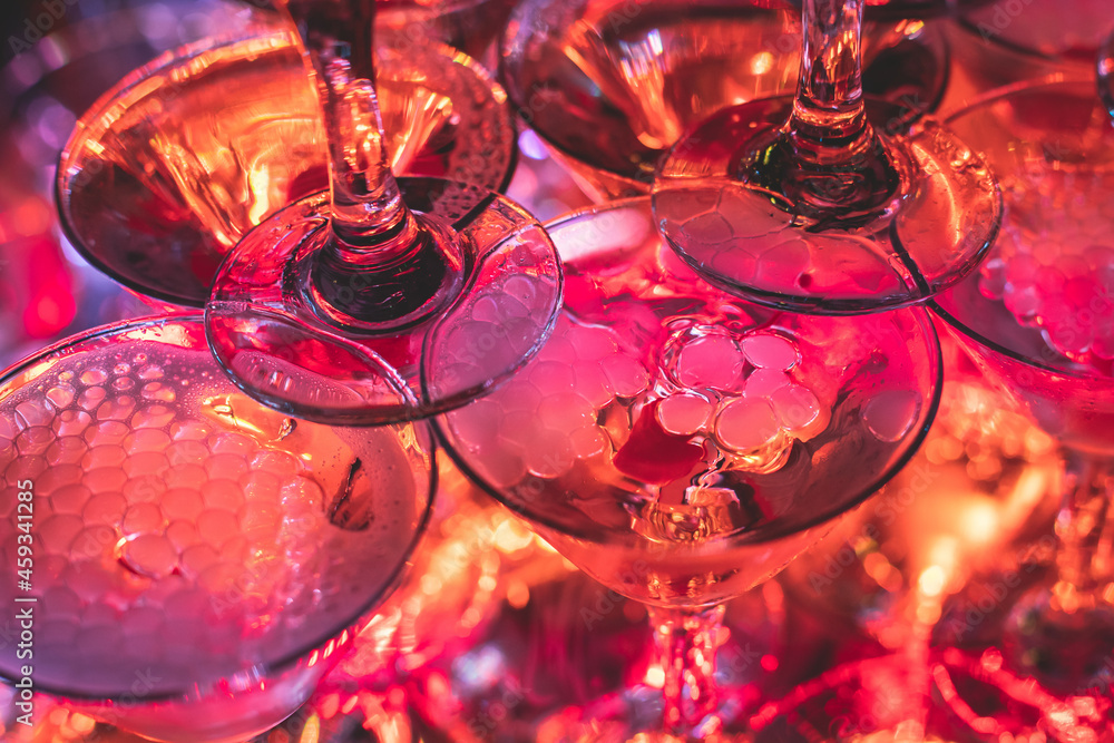 Pyramid of glasses with alcoholic beverages, filling and pouring ...