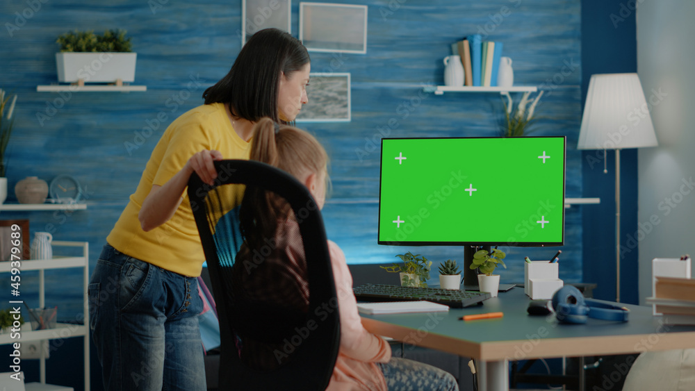 Mother and pupil doing homework with horizontal green screen on ...