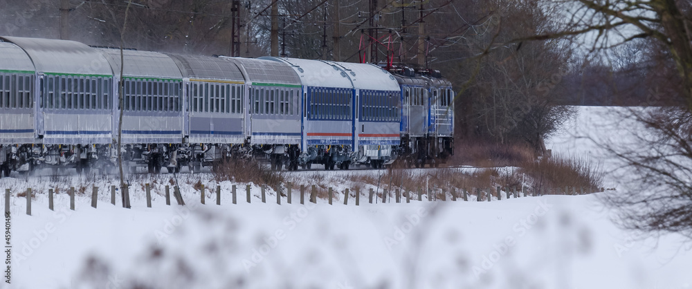 EXPRESS TRAIN - Passenger train goes along trail against background of ...