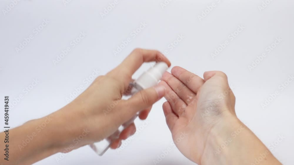 Hands spray and wash palms with antiseptic on a white background. The ...