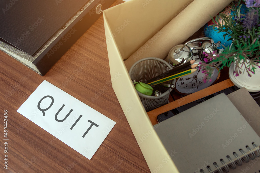 Quit job letter on desk office with collected office tools and ...