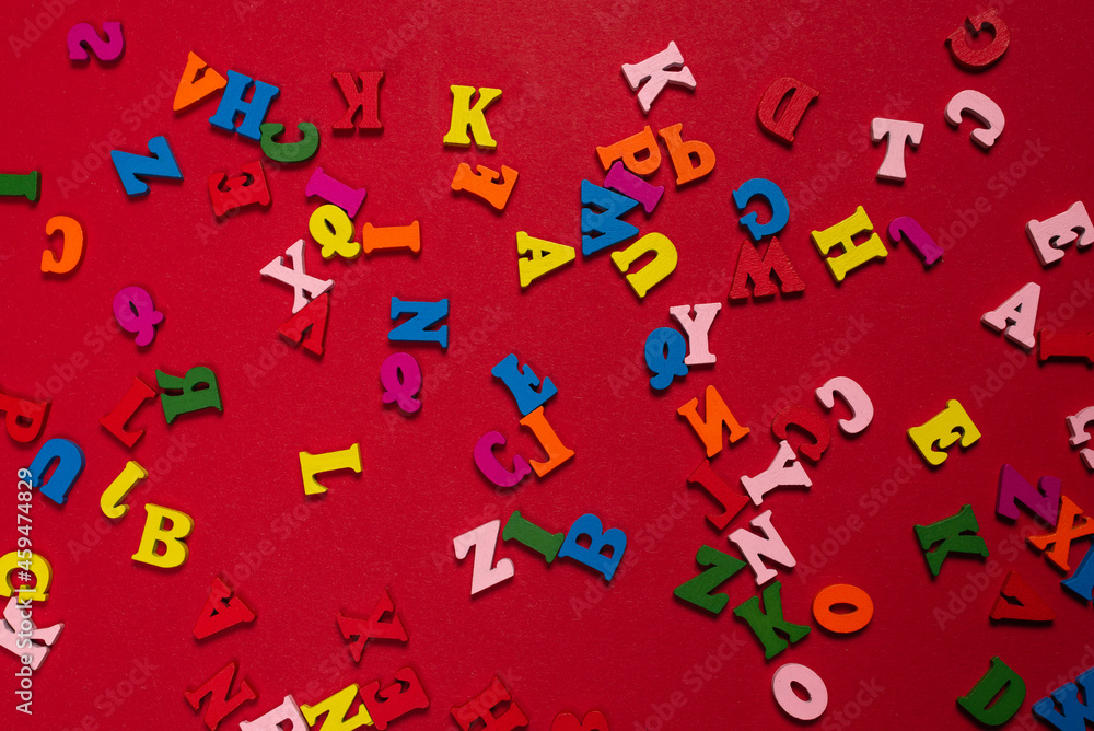 Random colorful alphabet on a red background, colorful letters. Stock ...