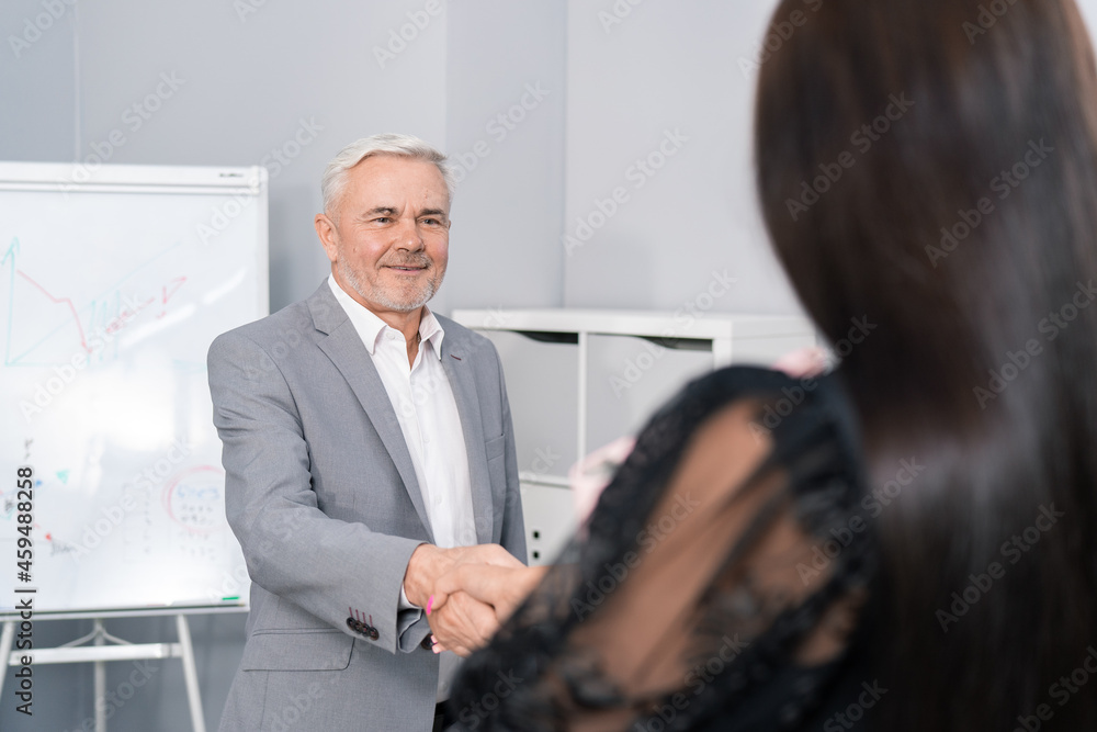 Elegantly dressed men with gray hair manager head of company rises from ...
