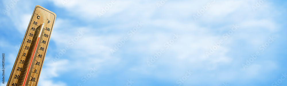 Wooden thermometer with red measuring liquid showing high temperature ...