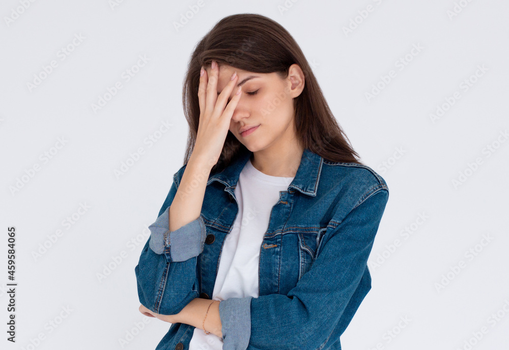 Stockfoto med beskrivningen Embarrassed annoyed adult woman hiding face ...