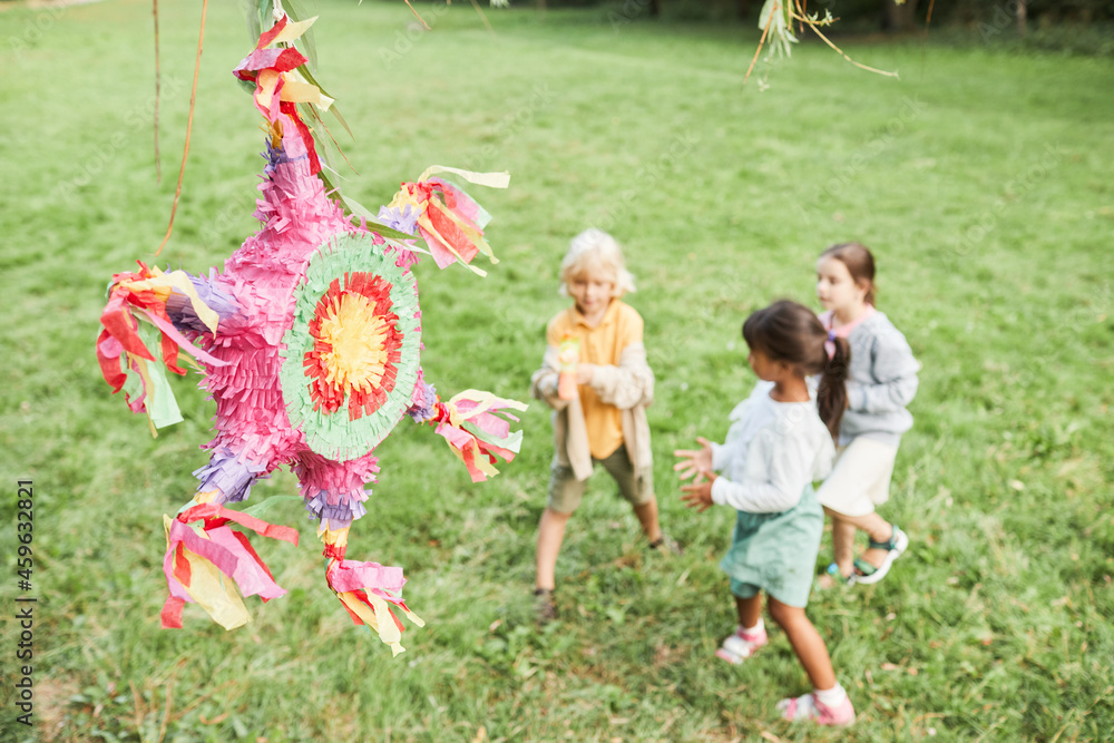 Background image of pink pinata at Birthday party with diverse group of ...