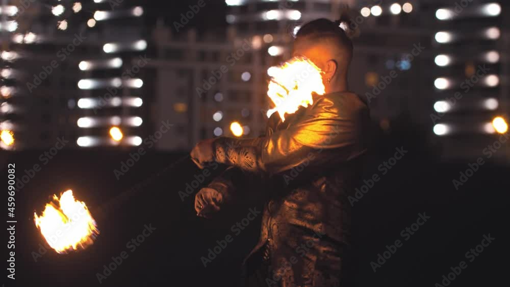 Bearded man performing on fire show - playing with fired up lanterns on ...