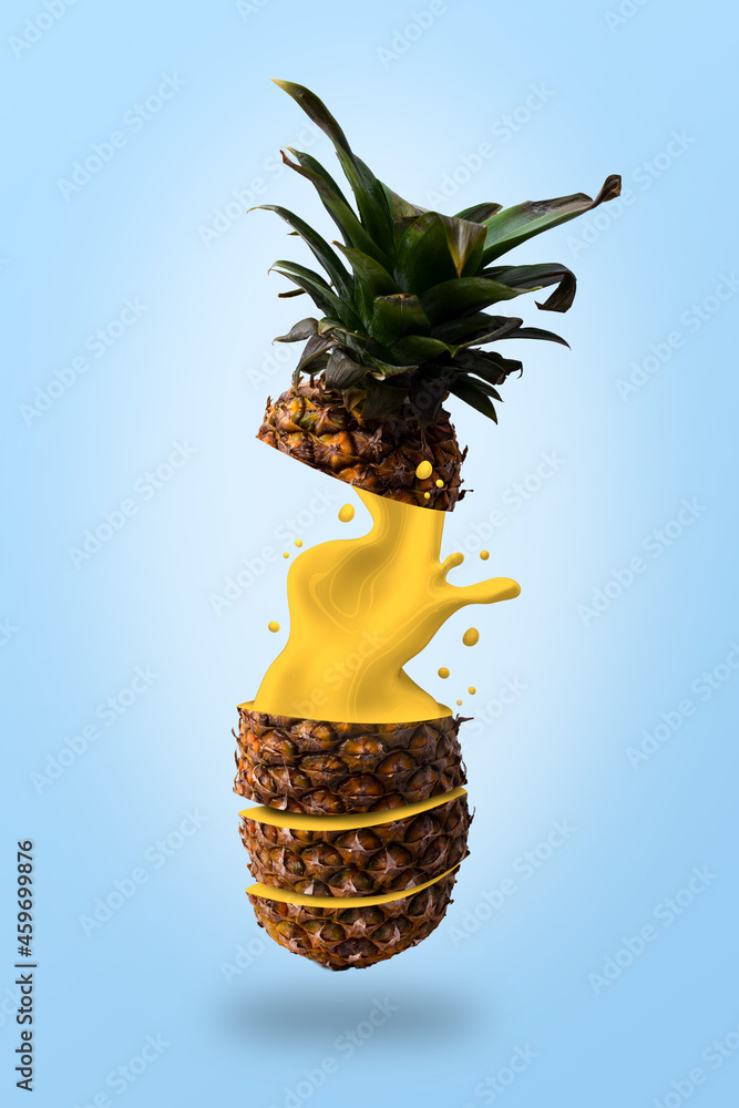 Ripe pineapple flying with yellow juice exploding on light blue ...