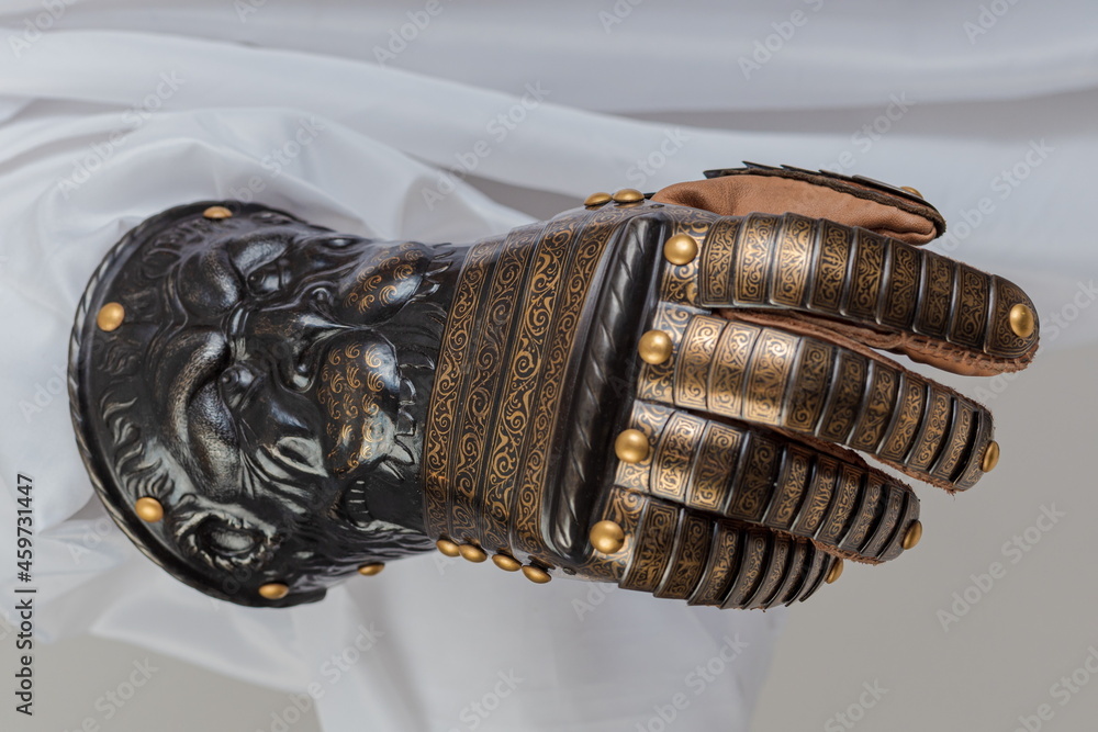Medieval knightly brown plate gauntlet from Italian armor, in the form ...