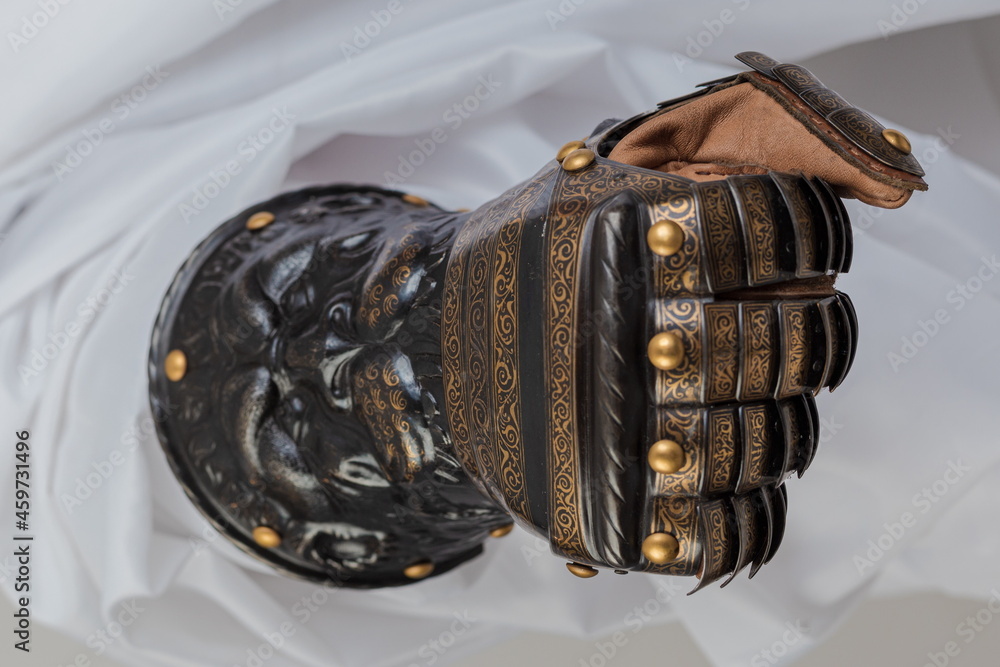 Medieval knightly brown plate gauntlet from Italian armor, in the form ...