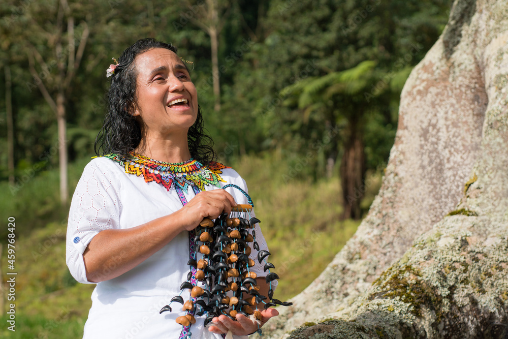 Woman playing an instrument outdoors. music in nature, indigenous ...