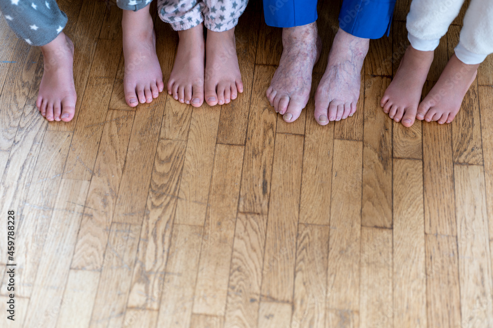 Several pairs of bare feet of people of different ages. Children and ...