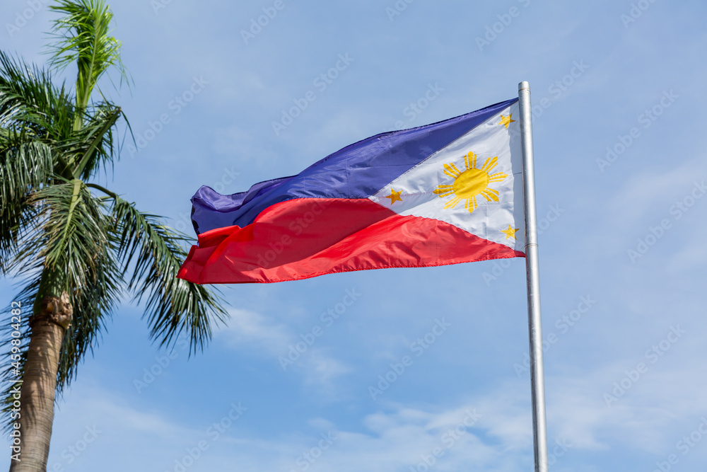filipino national flag fluttering in the wind and sky in the rizal park ...