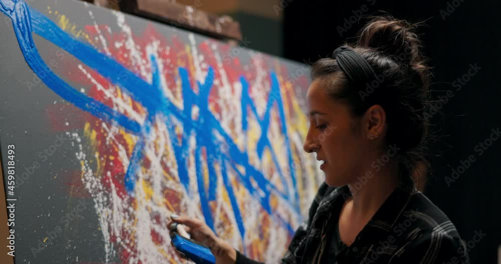 Talented artist hand paints oil paintings with blue paint with gentle ...